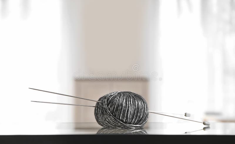 Knitting Thread with Needles on Glass Table Stock Photo - Image of ...