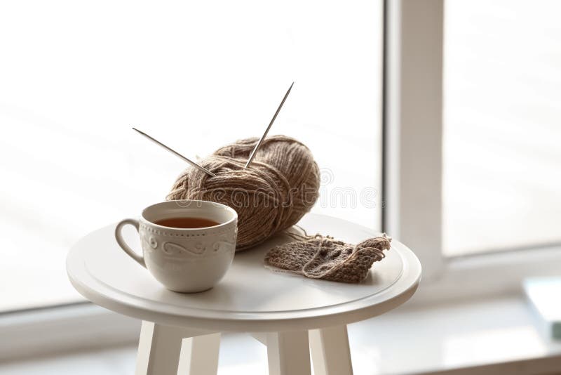 Knitting Threads with Needles and Cup of Tea on Table Stock Image ...