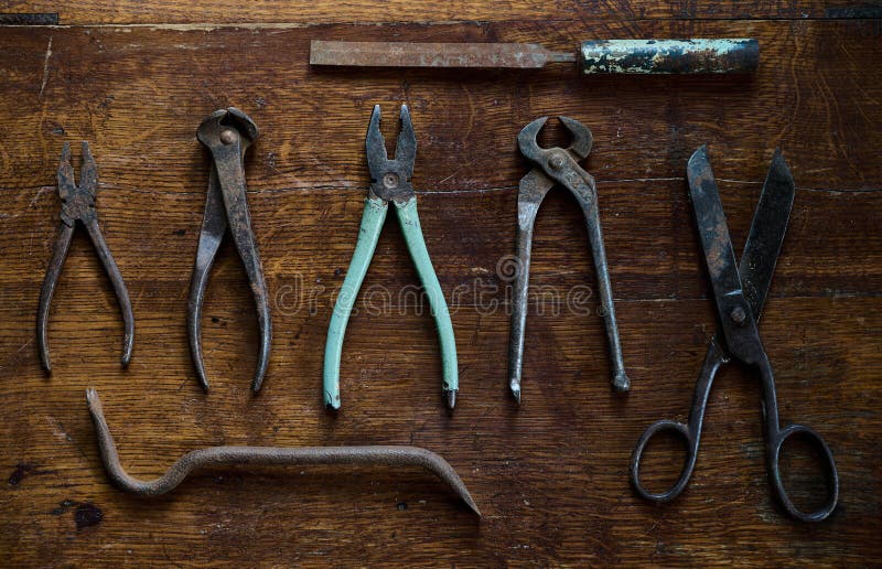 Knoling with Old and Rusty Tools on a Vintage Table Made of Lacquered ...