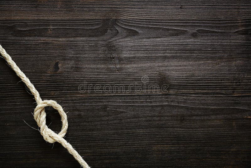 Knotted rope on dark wood stock image. Image of nodule - 85211185
