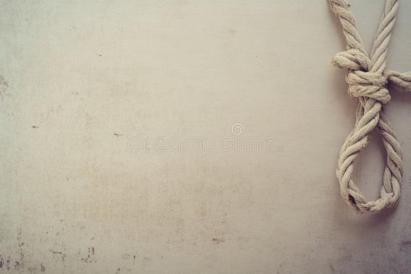 Knotted Rope Hanging Against a Textured Wall Highlighting Craftsmanship ...
