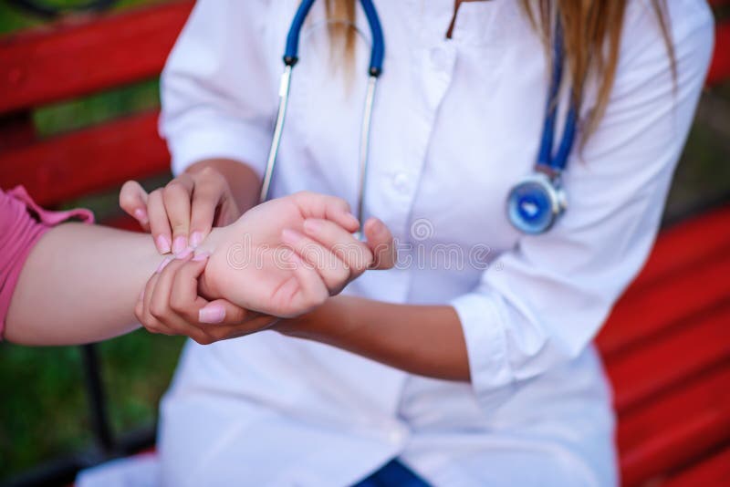 We Know the Pulse. Caring Doctor or Nurse Taking Young Patient O Stock ...