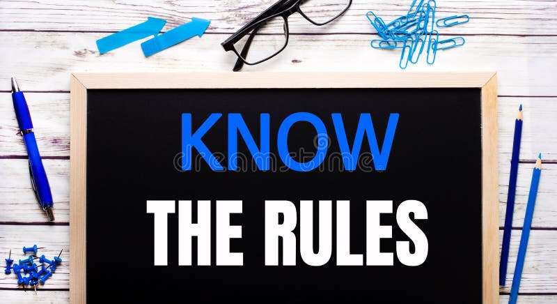 KNOW the RULES Written on a Black Note-board Next To Blue Paper Clips ...