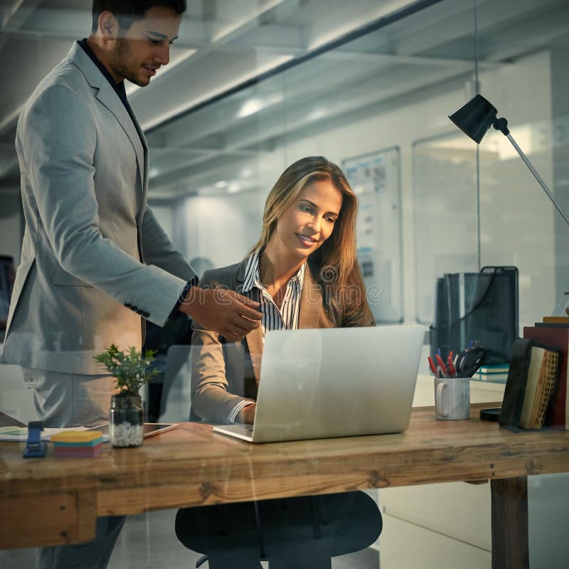 They Know the Value of Overtime. Colleagues Using a Laptop Together on ...