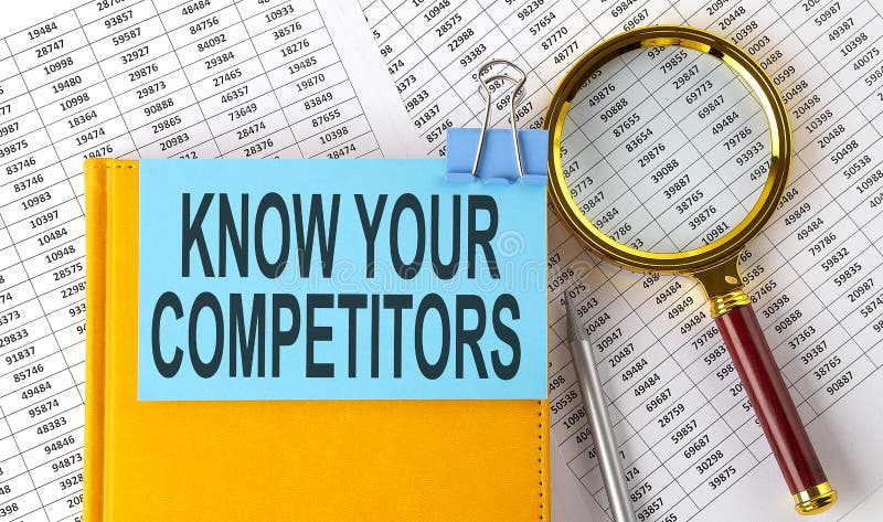 KNOW YOUR COMPETITORS Text on Sticker on Notebook with Magnifier and ...