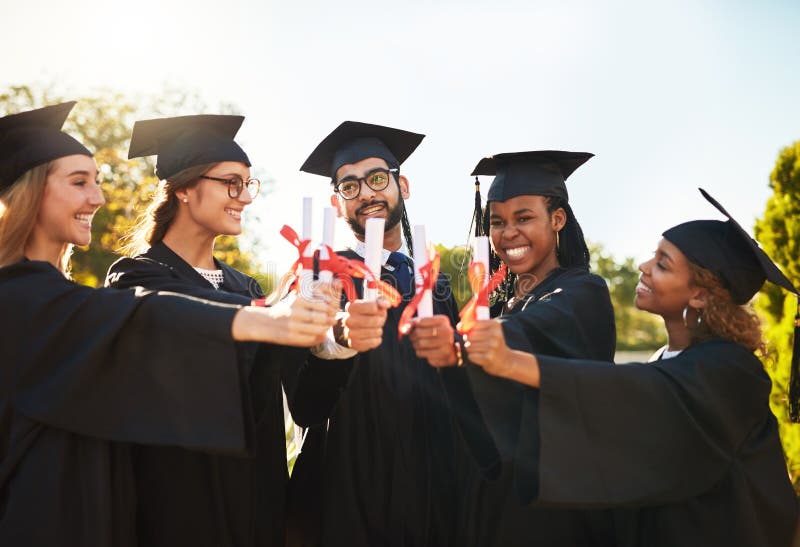 Knowledge is Indeed Power. a Group of University Graduates Holding Up ...