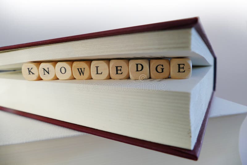 Knowledge Message Written in Wooden Blocks between Pages of a Bo Stock ...