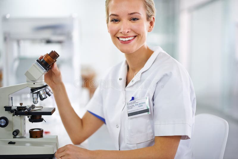 Knowledge is Power. a Beautiful Woman in a Laboratory Working with a ...