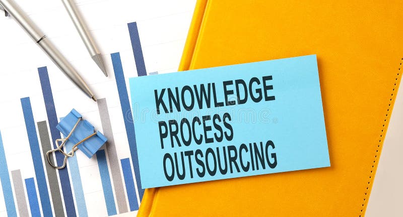 KNOWLEDGE PROCESS OUTSOURCING Text on Sticker on the Yellow Notebook ...