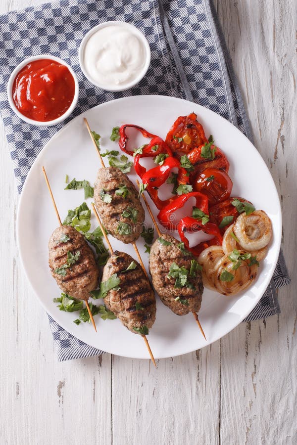 Kofta Kebab with Grilled Vegetables on a Plate and Sauce. Vertical Top ...