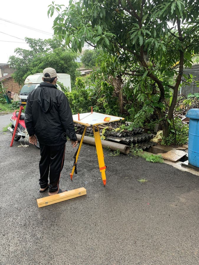 An Civil Engineer Doing Plane Table Survey at Construction Site ...