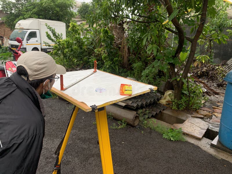 An Civil Engineer Doing Plane Table Survey at Construction Site ...