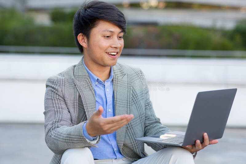 Korean Business Guy Engaged in Video Call on Computer Outdoor Stock ...