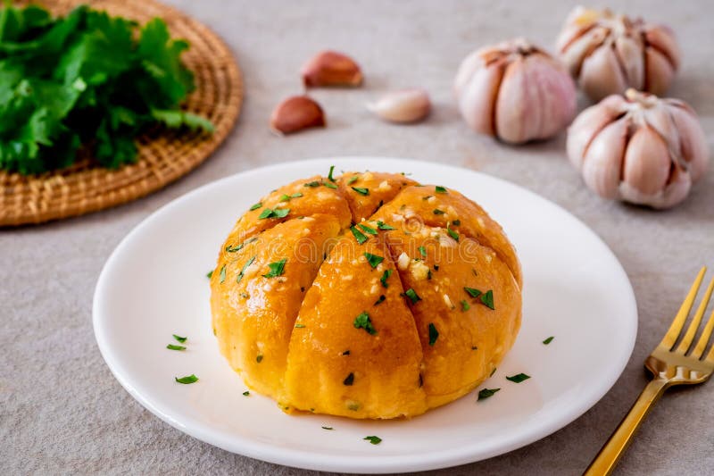 Korean Cream Cheese Garlic Bread on Plate and Raw Garlic Cloves Stock ...