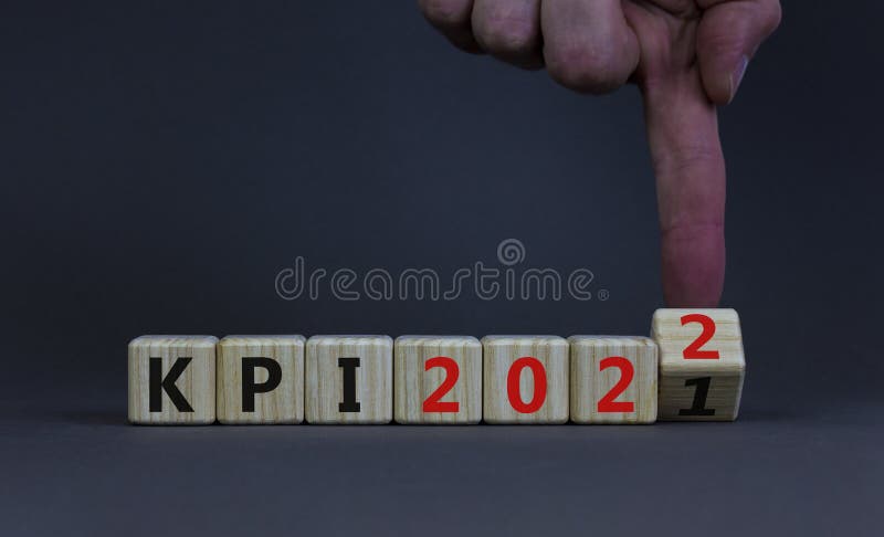 KPI, Key Performance Indicator Symbol. Businessman Turns Wooden Cubes ... KPI, Key Performance Indicator Symbol. Businessman Turns Wooden Cubes ...