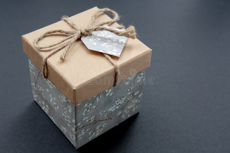 Kraft Gift Box on a Dark Contrasted Background, Decorated with a ...