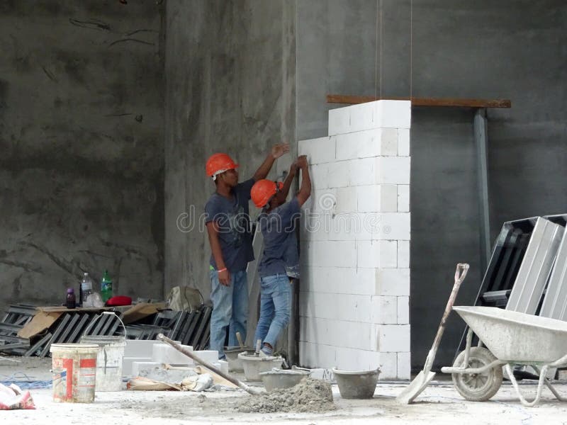 Brickwork by Construction Workers at the Construction Site. Editorial ...