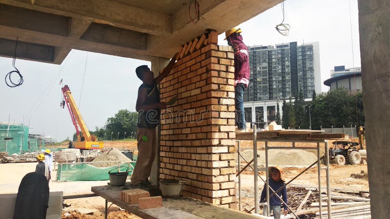 Brickwork by Construction Workers at the Construction Site. Editorial ...
