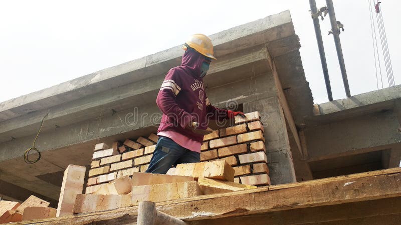Brickwork by Construction Workers at the Construction Site. Editorial ...