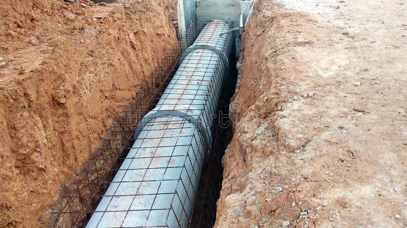 Construction Workers Install Concrete Pipe Culvert in the Underground ...