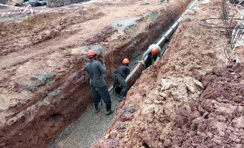Underground Sewerage Pipe Installed by Construction Workers at the ...