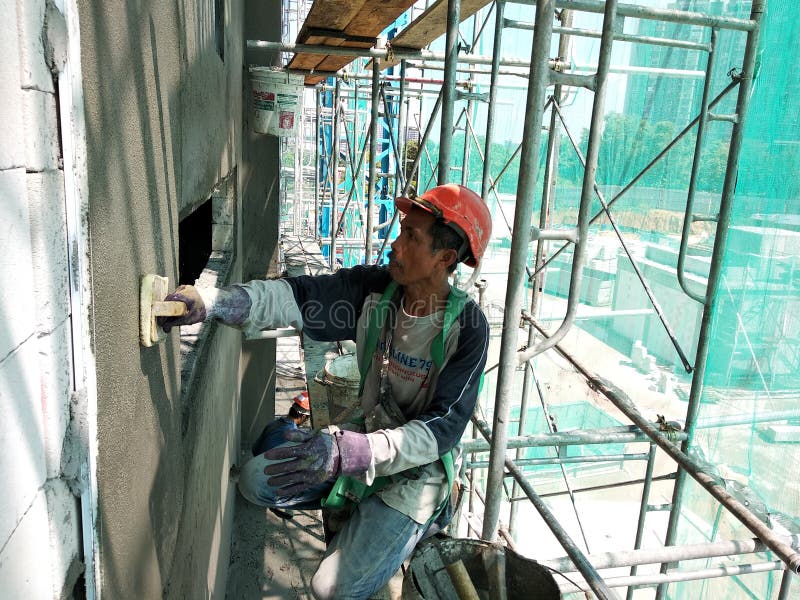 Construction Workers Plastering Wall Using Cement Plaster at the ...