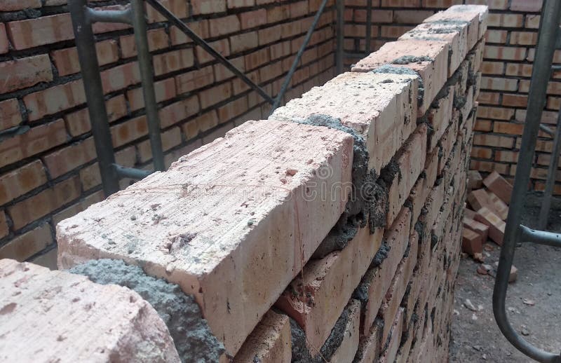 Brickwork by Construction Workers at the Construction Site. Editorial ...