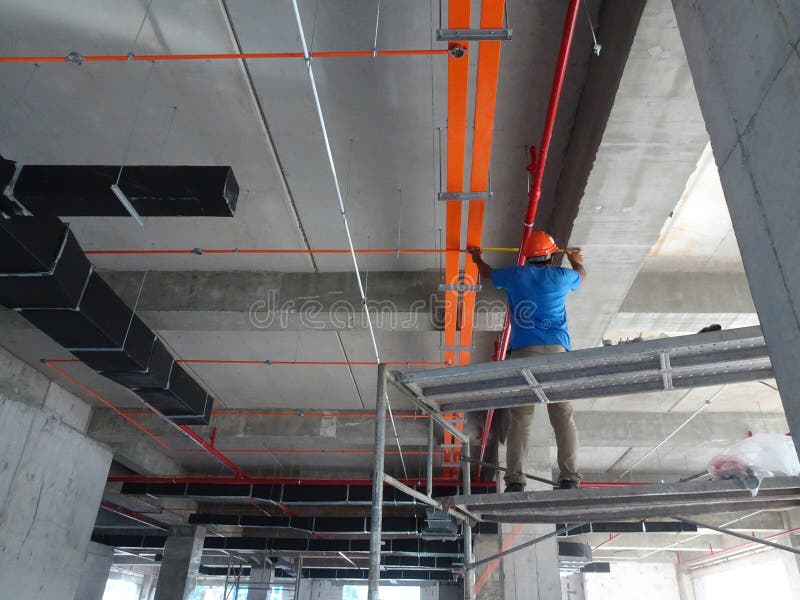 Construction Workers Installing Electrical Cable Tray on the Floor ...