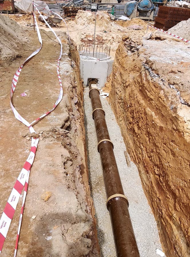 Underground Utility and Services Pipe Laid by Workers in the Trenches ...