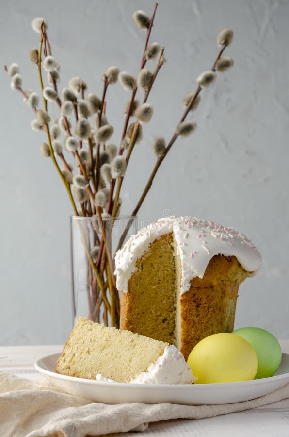Kulich Easter Cake with Colored Eggs with White Glaze on White Wooden ...