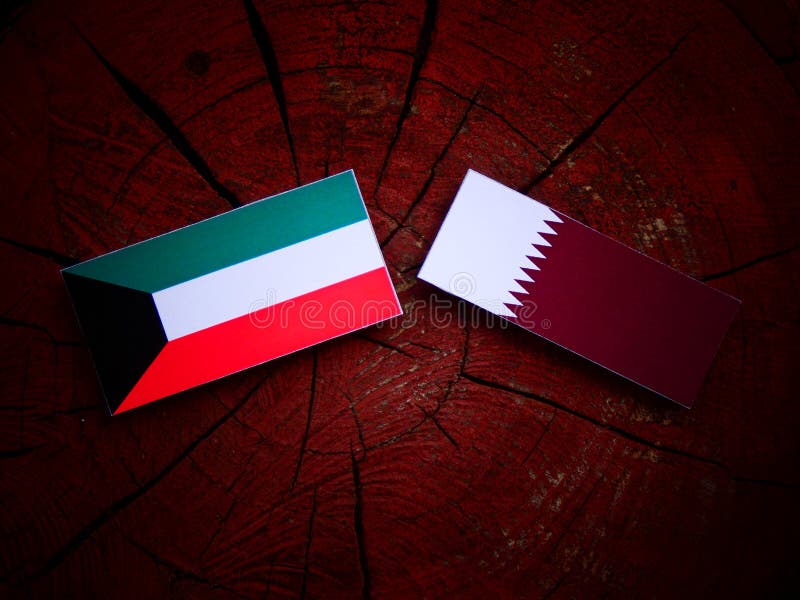 Kuwaiti Flag with Qatari Flag on a Tree Stump Isolated Stock Photo ...