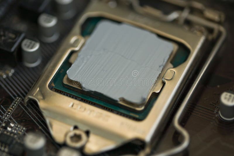 KYIV, UKRAINE - JANUARY 29, 2025 Applying Thermal Paste on a Processor for Better Cooling ...