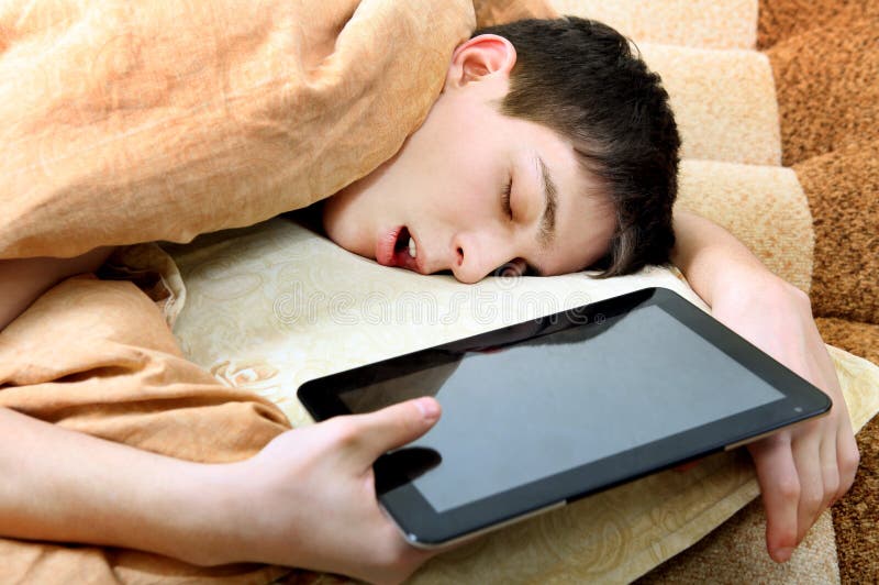 L'adolescente Dorme Con La Compressa Fotografia Stock - Immagine di ...