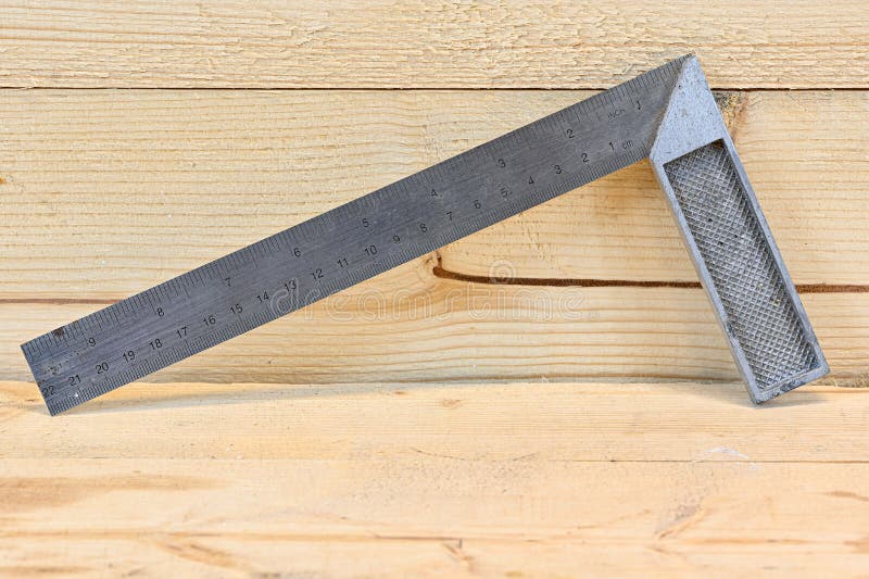 L Square of Metal Standing on Wooden Bench Stock Image - Image of ...