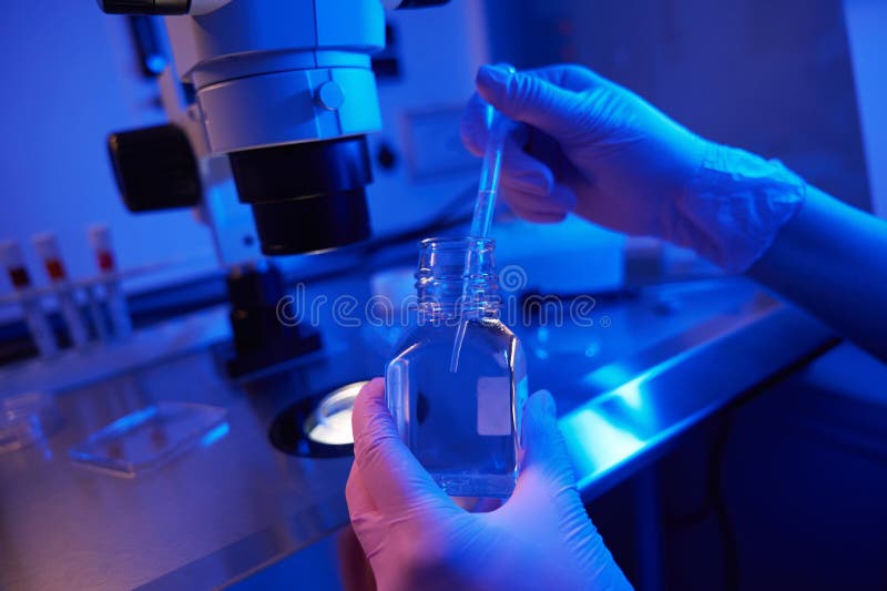 Lab Scientist Aspirating Liquid with Pasteur Pipette from Reagent ...