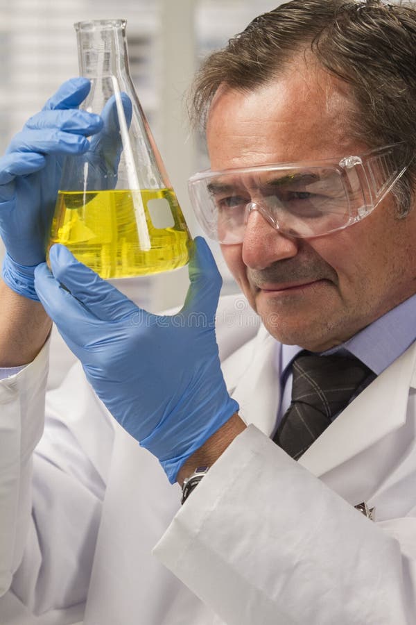 Lab Scientist Examining Beaker, Horizontal Stock Image - Image of ...