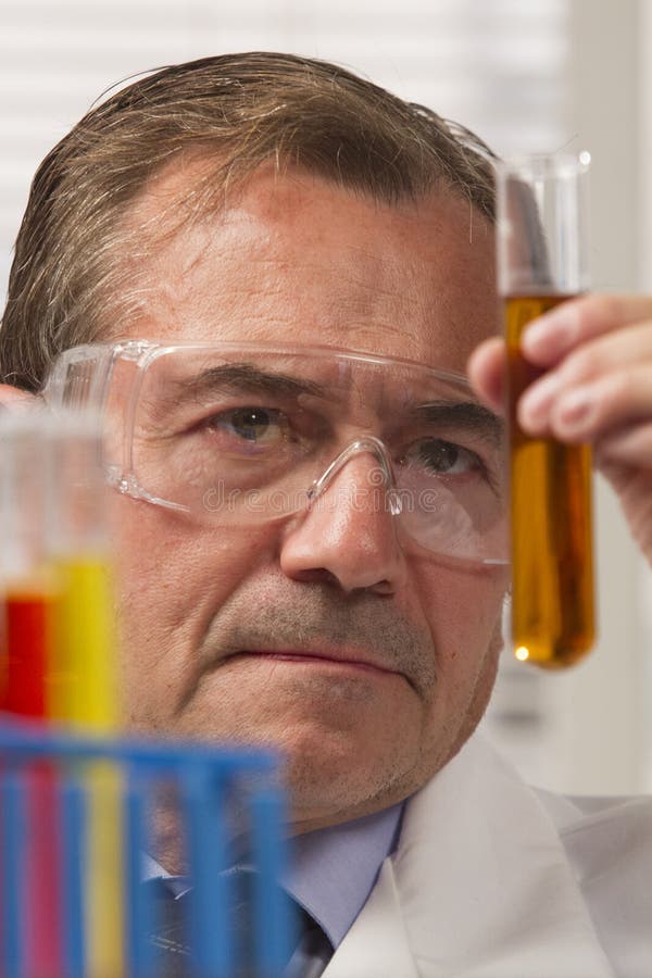 Lab Scientist Examining Test Tube, Vertical Stock Photo - Image of ...