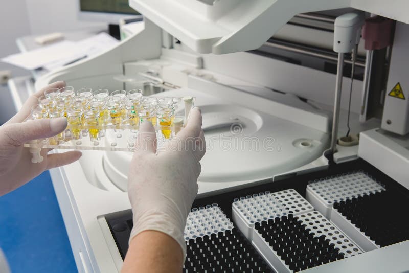 Lab Tech Loading Samples into a Chemistry Analyzer Stock Image - Image ...