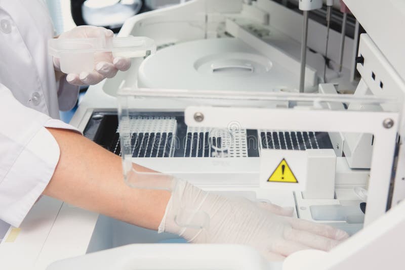 Lab Tech Loading Samples into a Chemistry Analyzer Stock Photo - Image ...