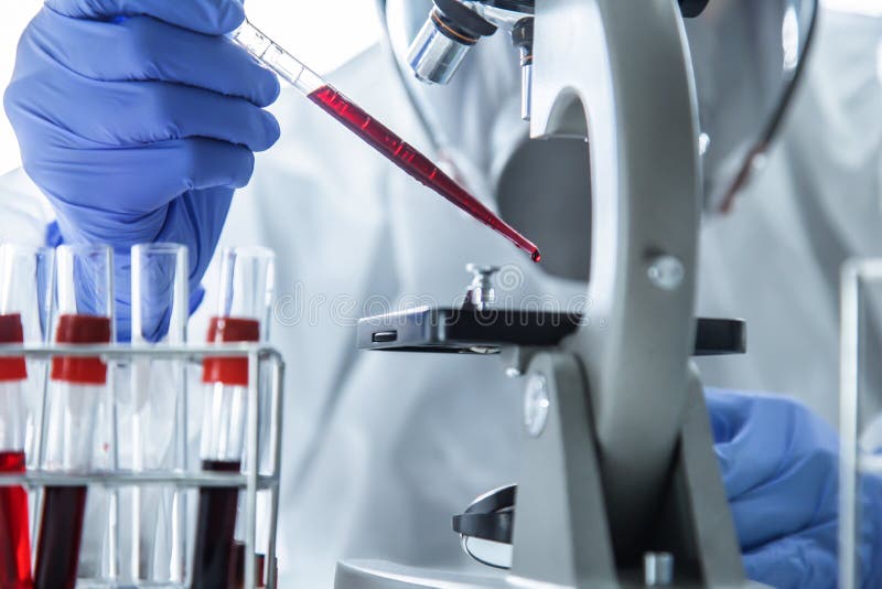 Lab Technician Analyzing a Blood Sample in Test Tube at Laboratory with ...