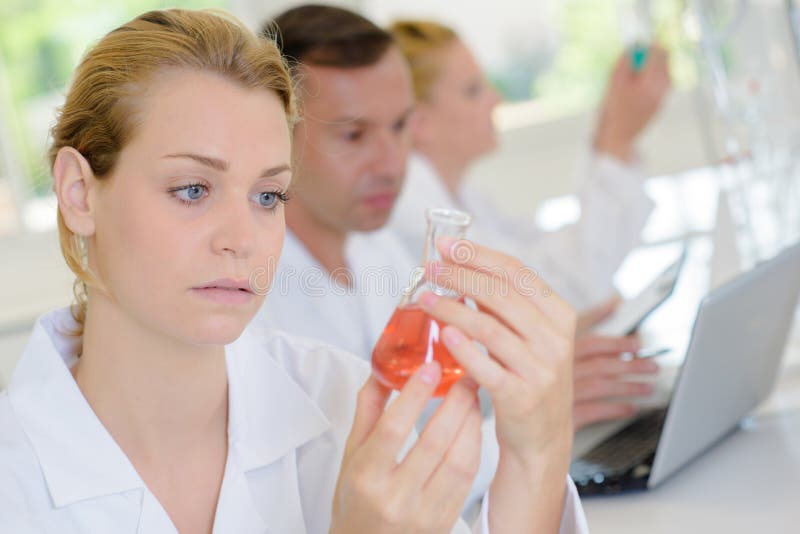 Lab Technician Checking Solutions Stock Image - Image of coat, computer ...