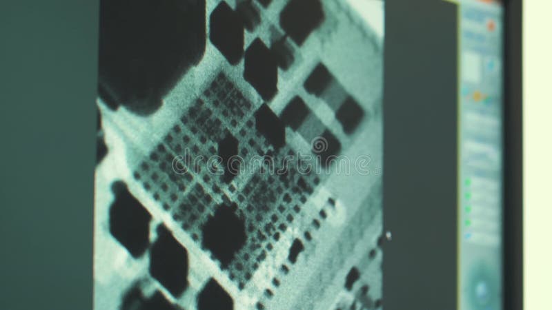 Lab Technician Examines an X-ray Image of a Microcircuit on a Computer ...