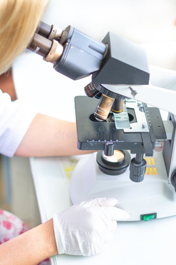 The Lab Technician Looks into the Microscope and Records and Analyzes ...