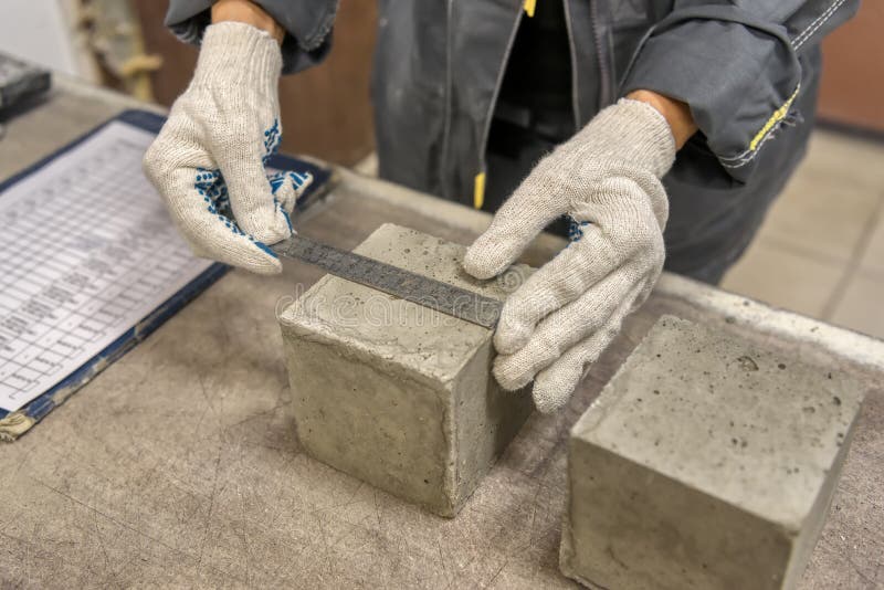 Lab Technician Measures the Size of a Concrete Cube Using a Metal Ruler ...