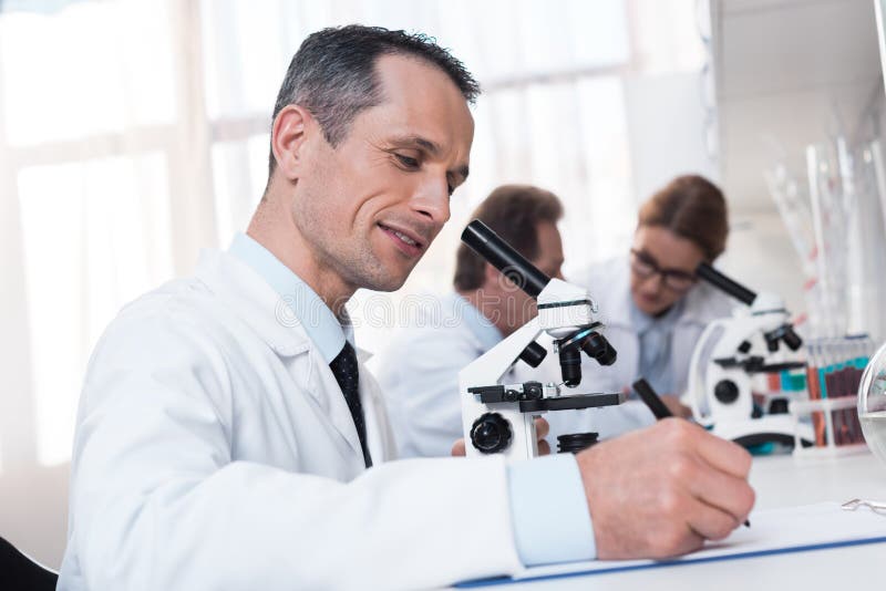 Lab Technician Taking Notes Stock Image - Image of profession ...