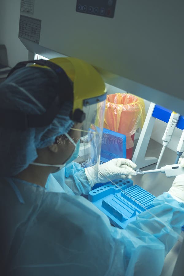 A Lab Technician Uses a Pipette To Transfer a Liquid Solution into a ...