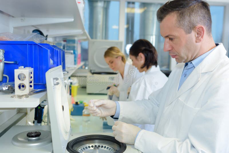 Friendly Female Lab Technician Using a Microscope. Stock Photo - Image ...
