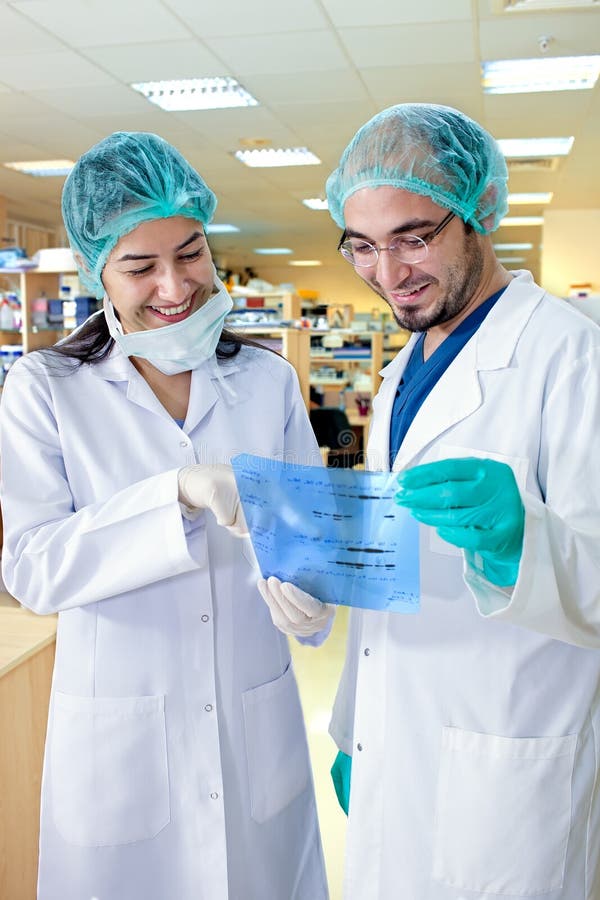 Lab Technicians Smiling As they Study the Results. Stock Photo - Image ...