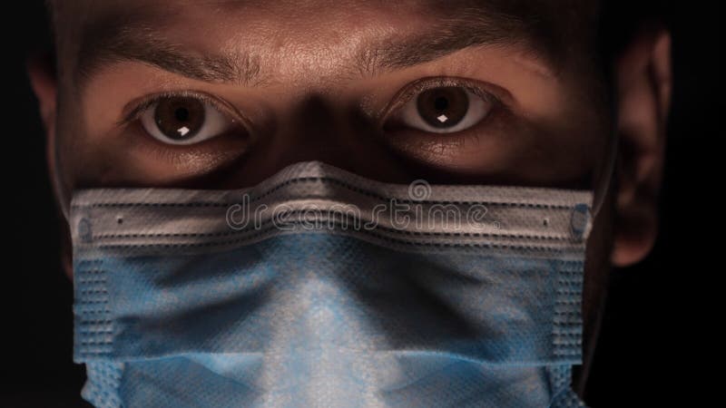 A Lab Worker in a Mask Puts on Protective Work Glasses for Working in ...