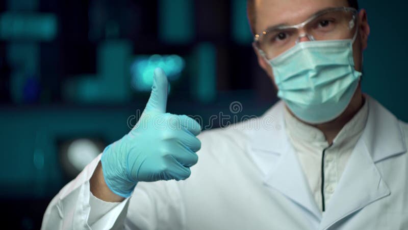 A Lab Worker in a Mask Puts on Protective Work Glasses for Working in ...